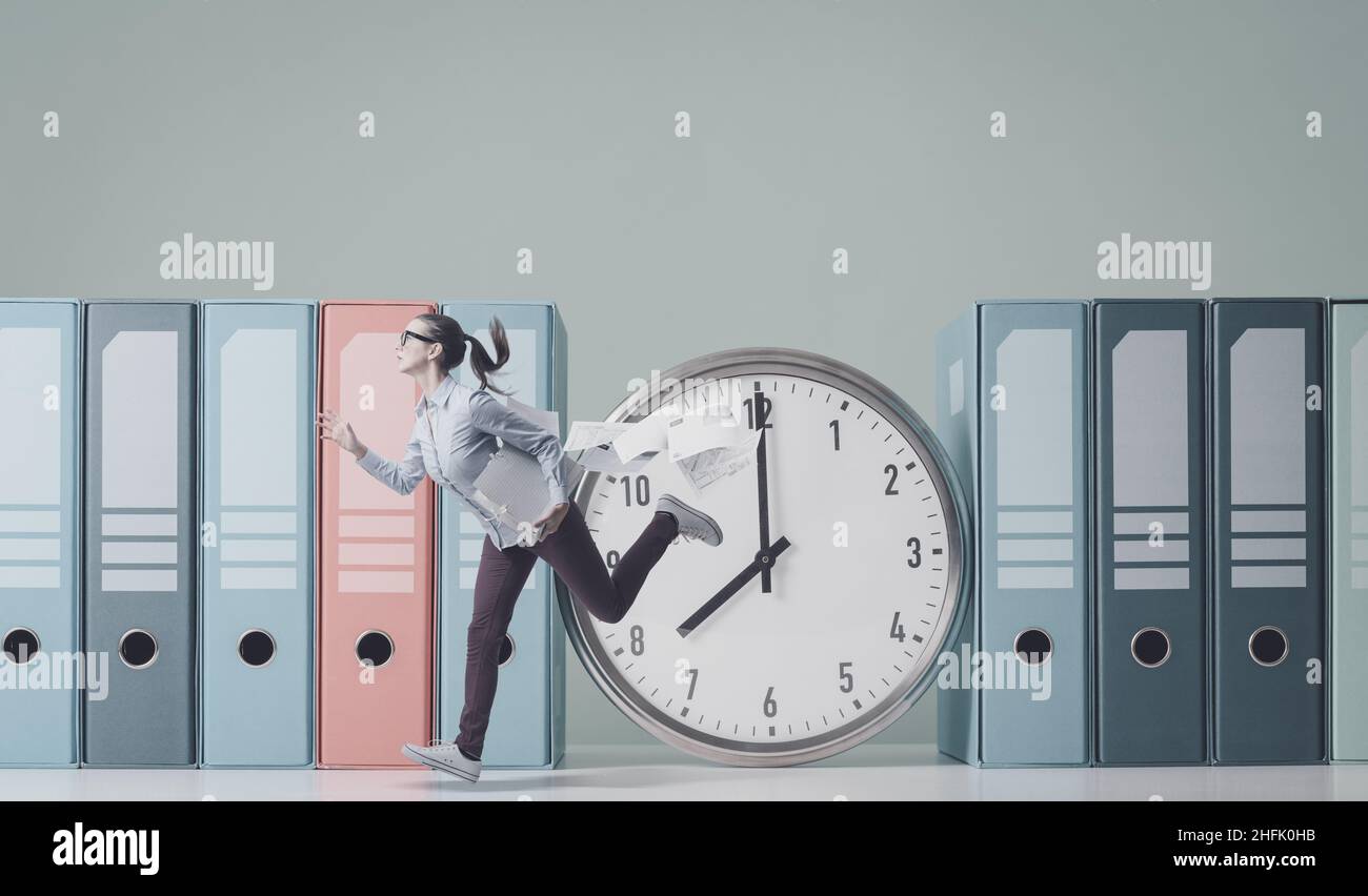 Stressed woman running fast and huge clock: time management and ...