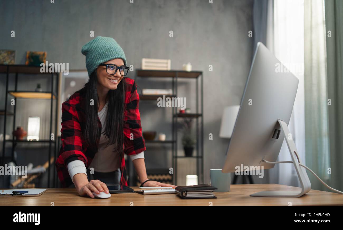 Happy female video editor works indoors in creative office studio Stock ...