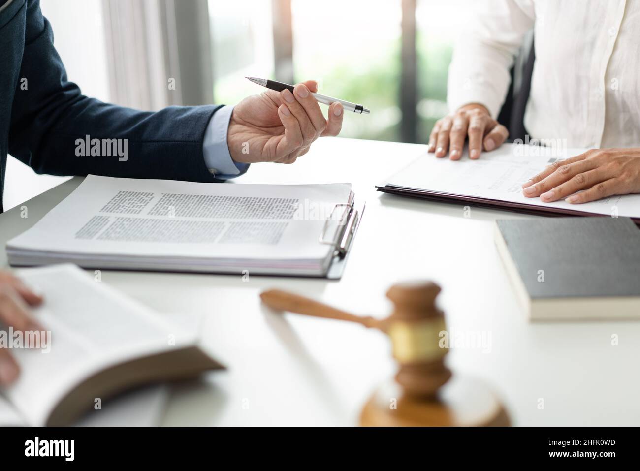 law concept The solicitor, the man in blue suit, giving his pen to his ...