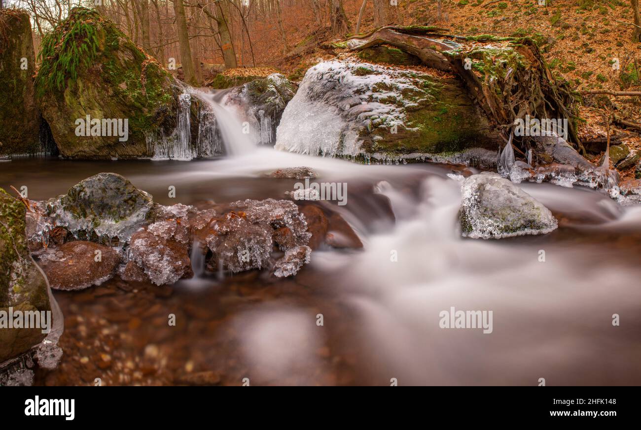 Waterfall cascades in cold winter temperatures. Frozen waterfall Stock ...