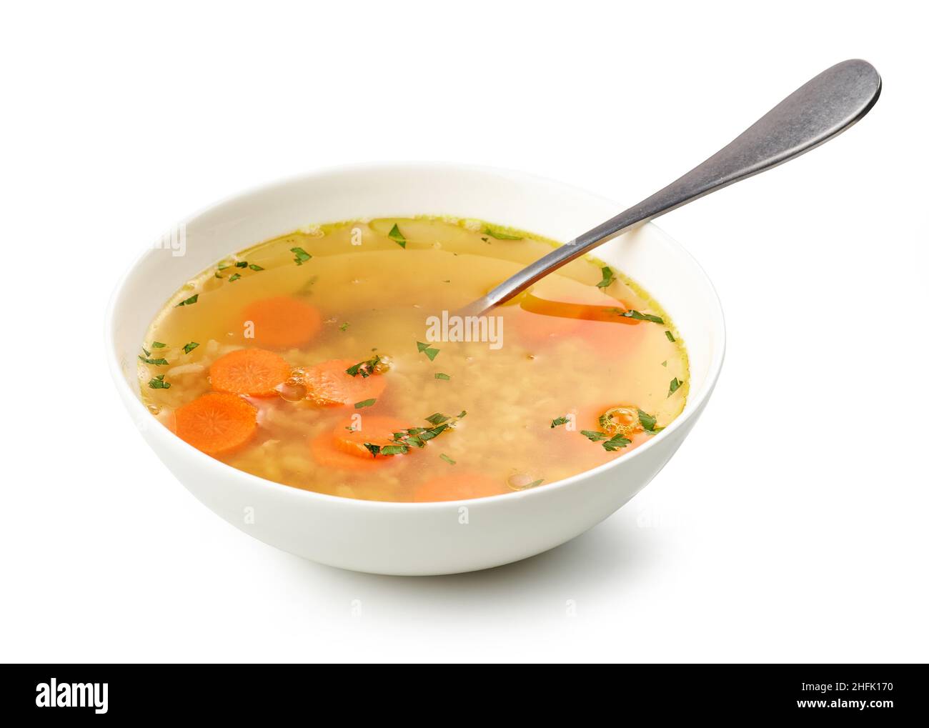bowl of chicken broth soup with vegetables and rice isolated on white ...
