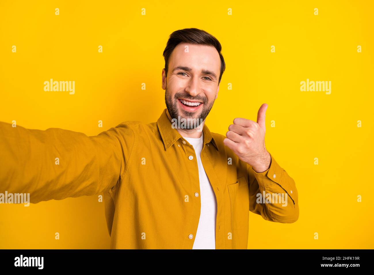Photo of young excited man happy positive smile shoot selfie show thumb ...