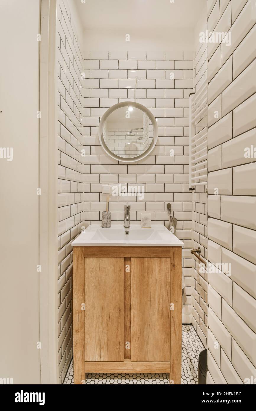 Adorable washbasin with white tiled walls and a comfortable sink Stock ...