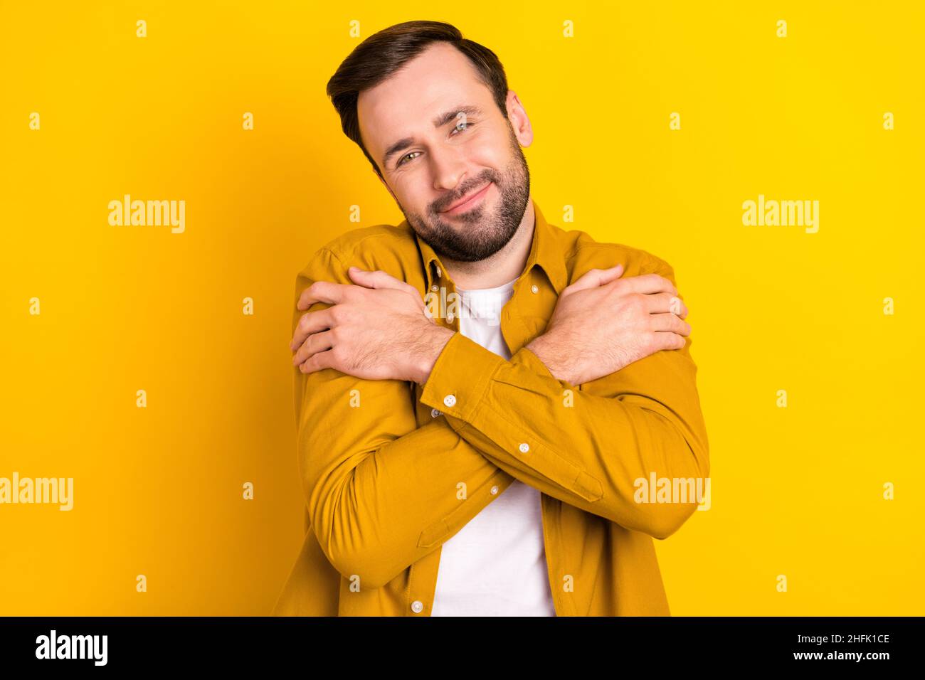 Photo of young man happy positive smile hug cuddle himself comfort cozy ...