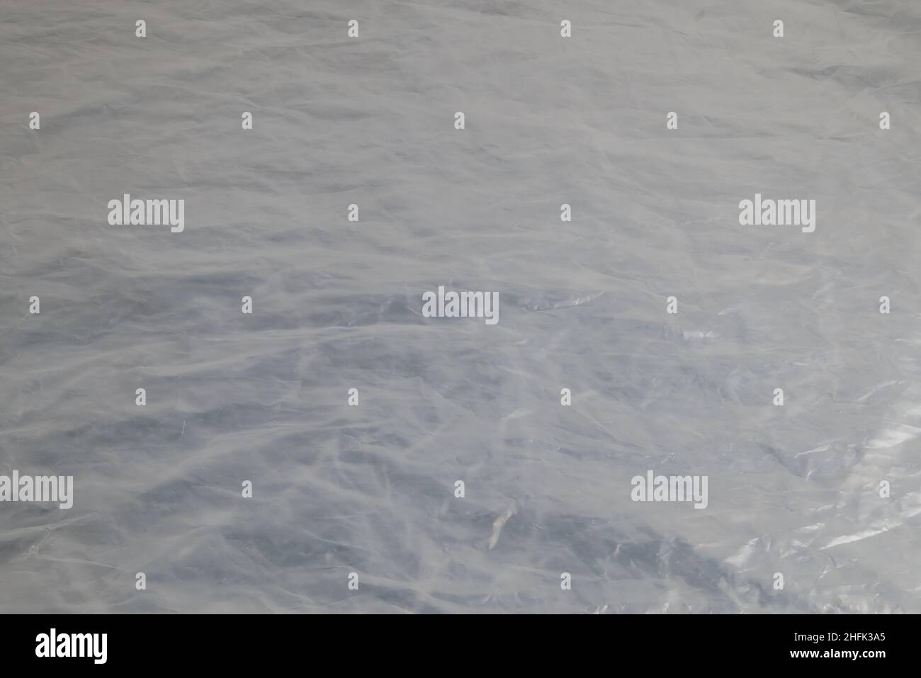 full frame background of flat crumpled semi-transparent polyethylene ...
