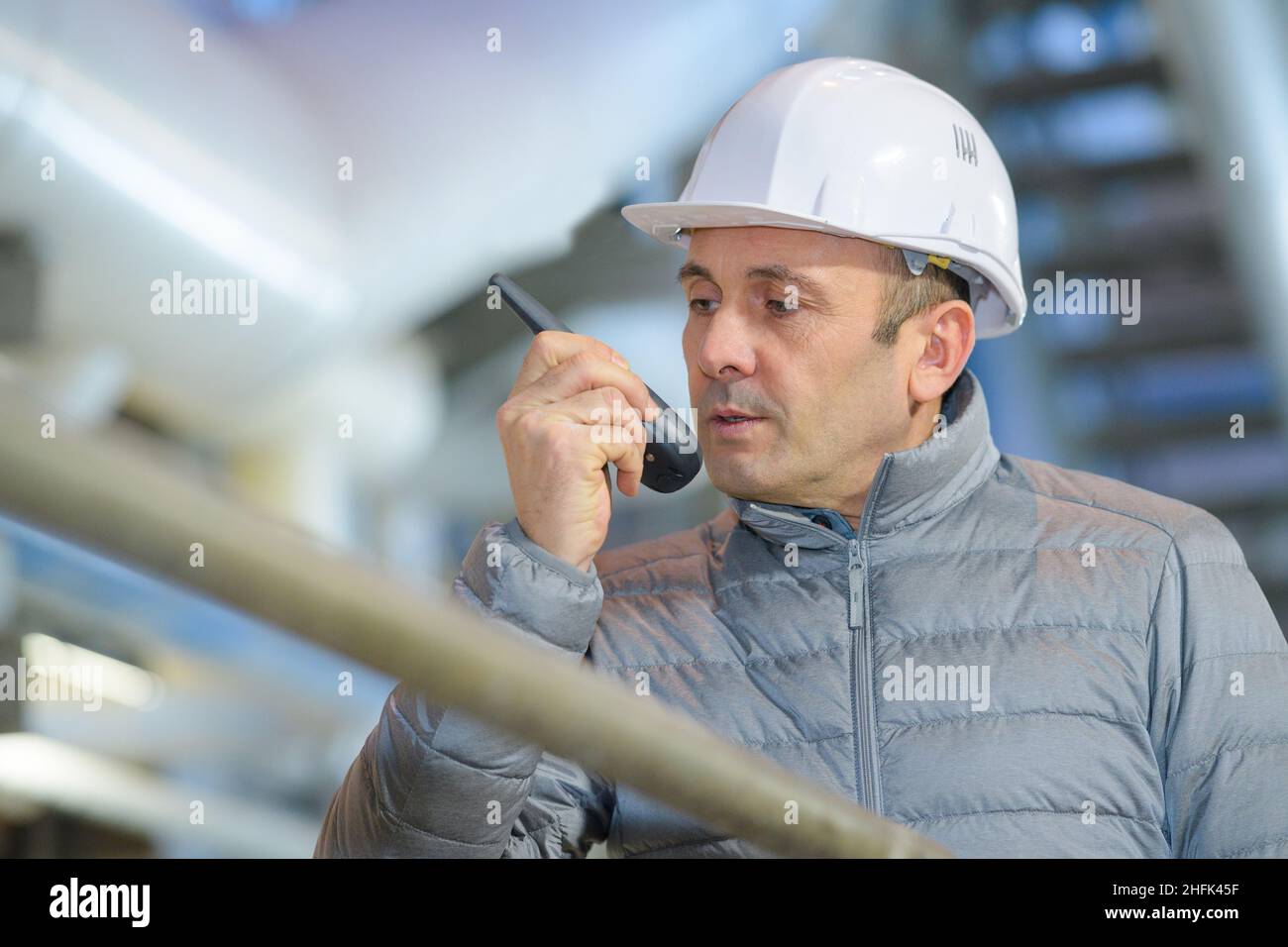 industrial technician talking in walkietalkie Stock Photo - Alamy