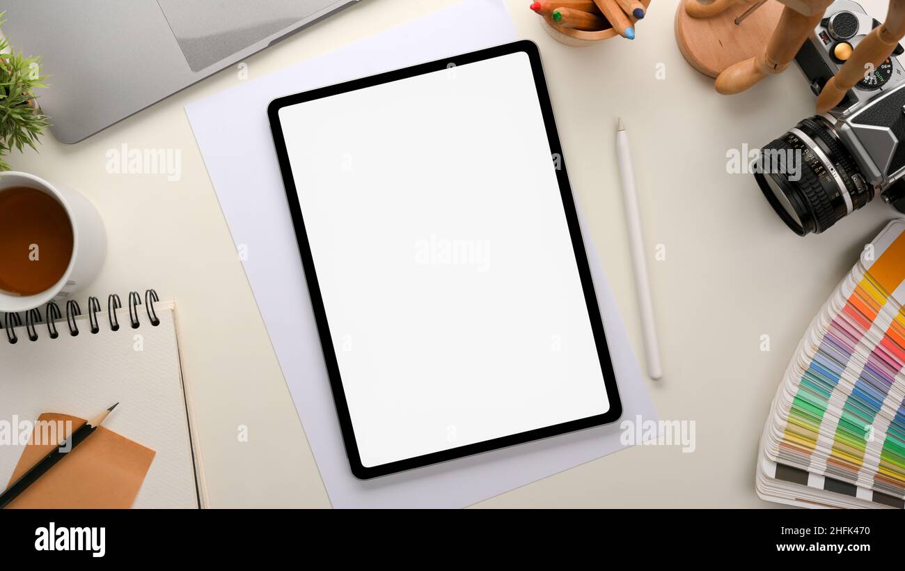 Creative graphic designer workspace with wireless touchpad computer and office supplies on white ...