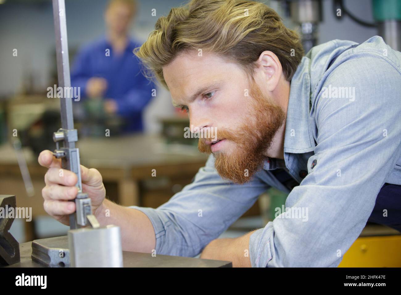 man measure part accuracy by dial guage Stock Photo - Alamy