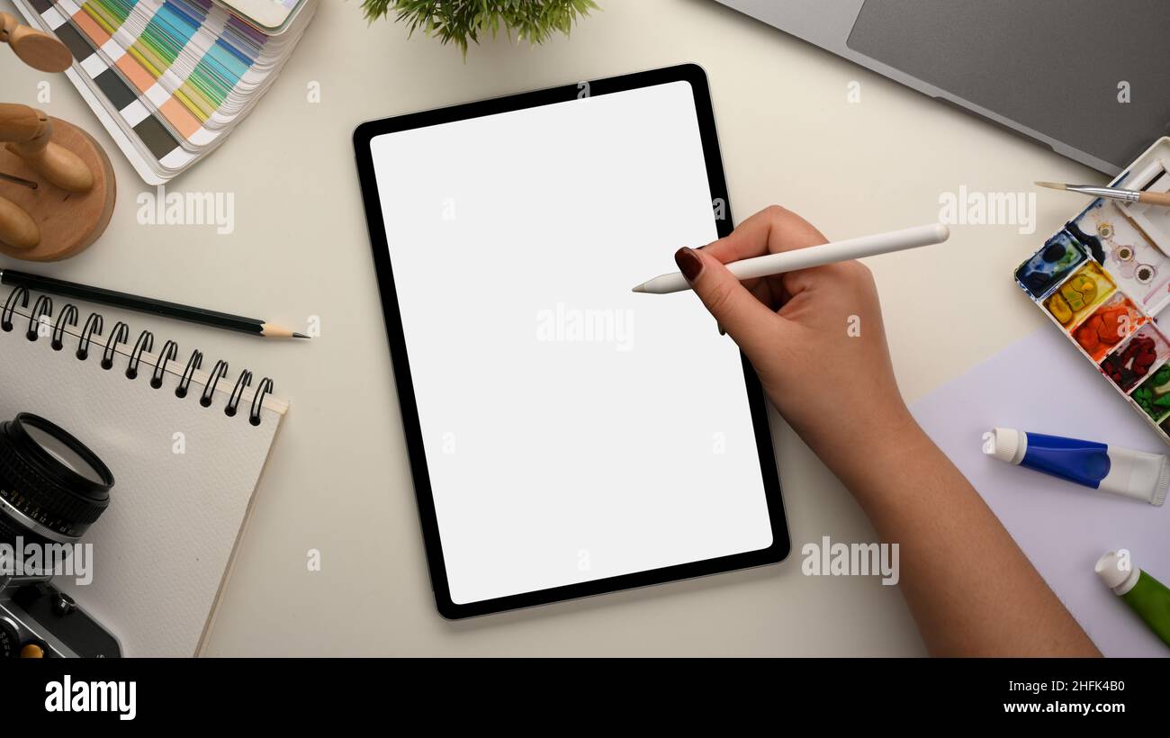 Graphic designer workspace concept with female hands using stylus pen ...
