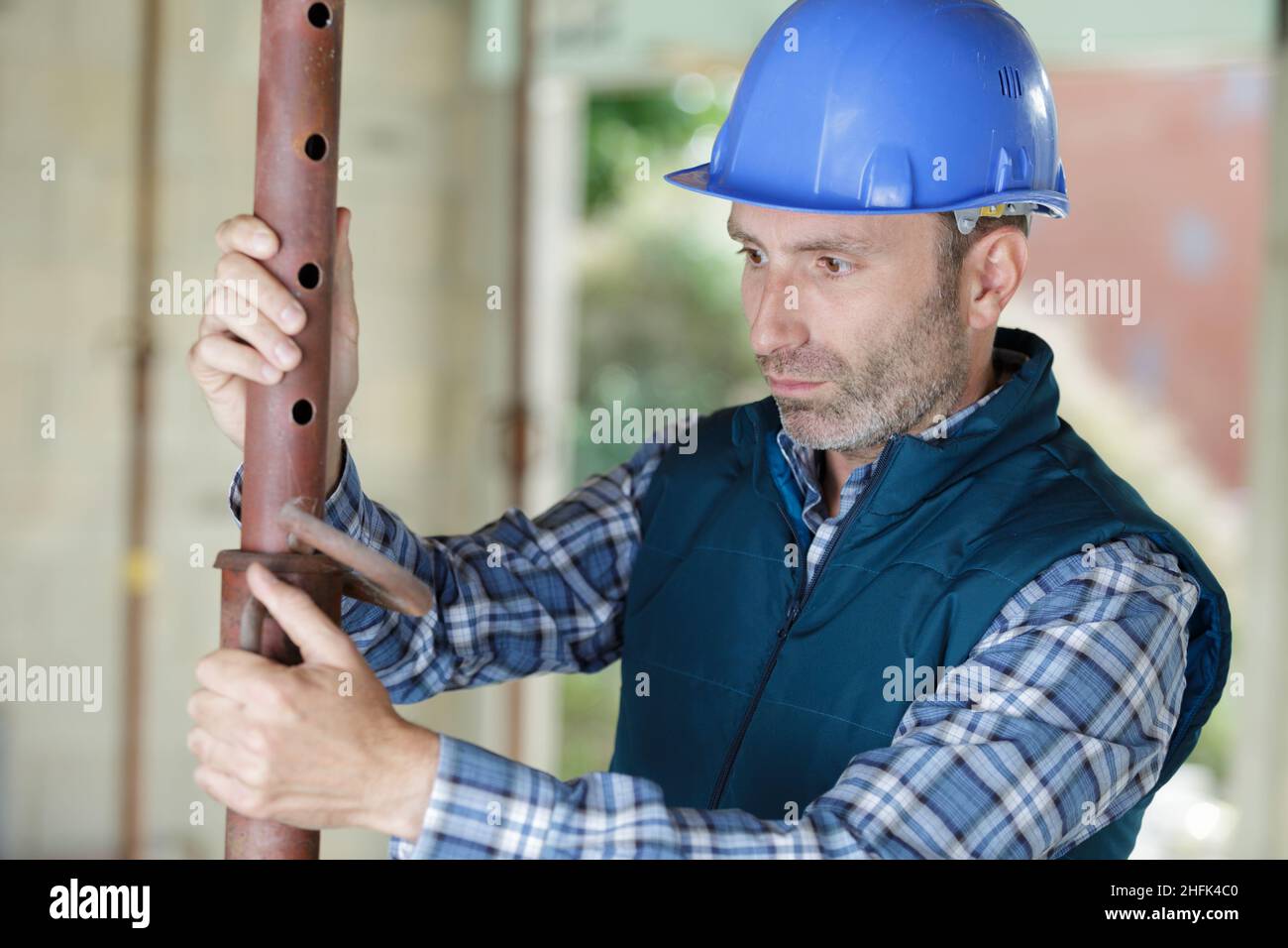 man builder working with pipes structure Stock Photo - Alamy
