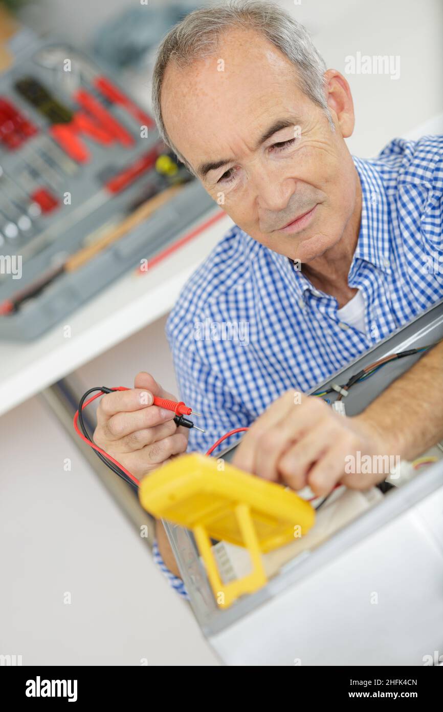 a senior serviceman using multimeter Stock Photo - Alamy