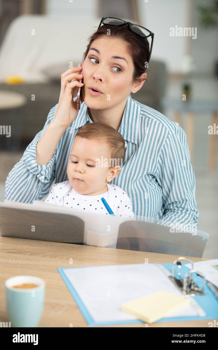 business mother works at home with her baby Stock Photo - Alamy