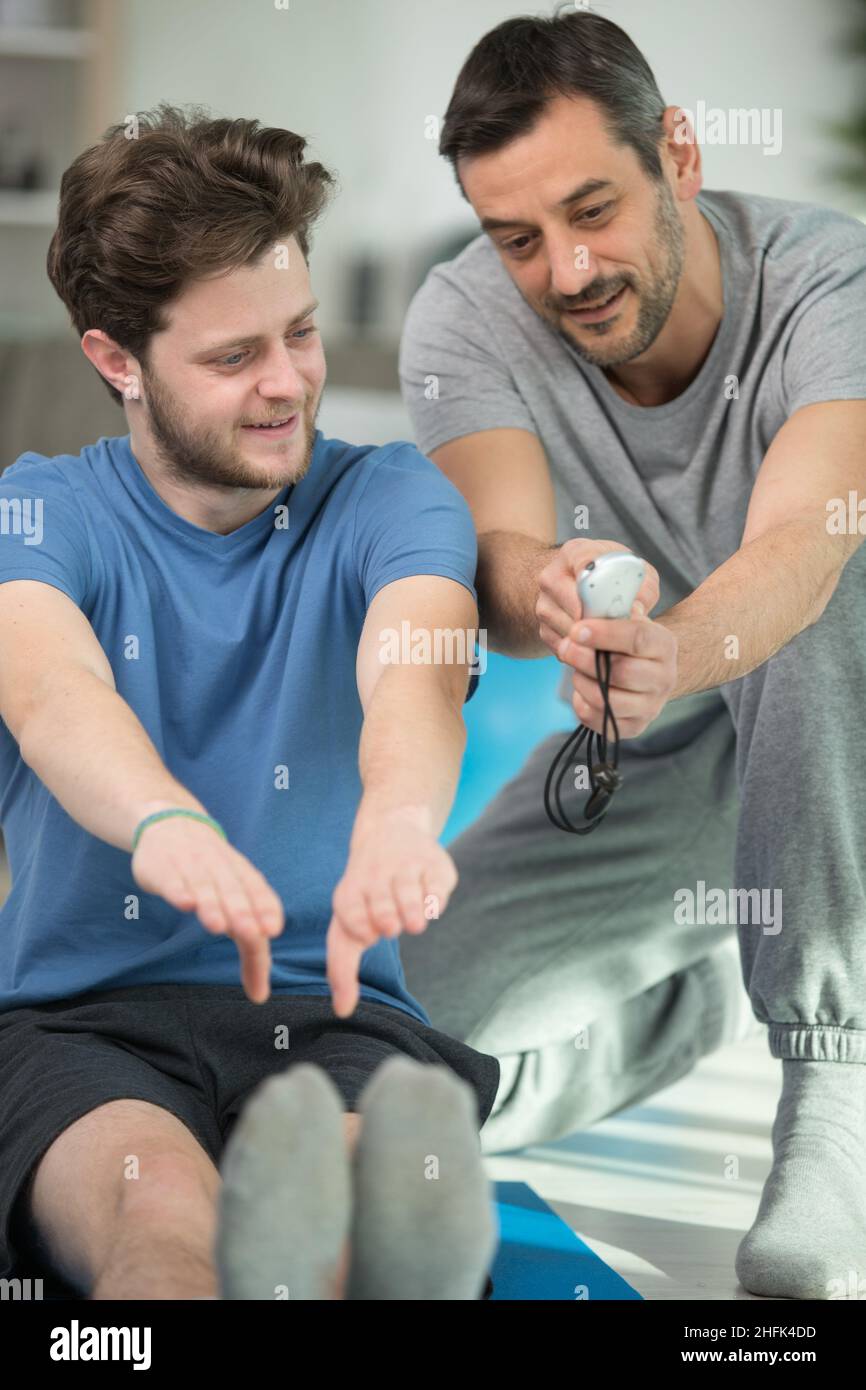 young man doing exercises with his personal trainer Stock Photo - Alamy