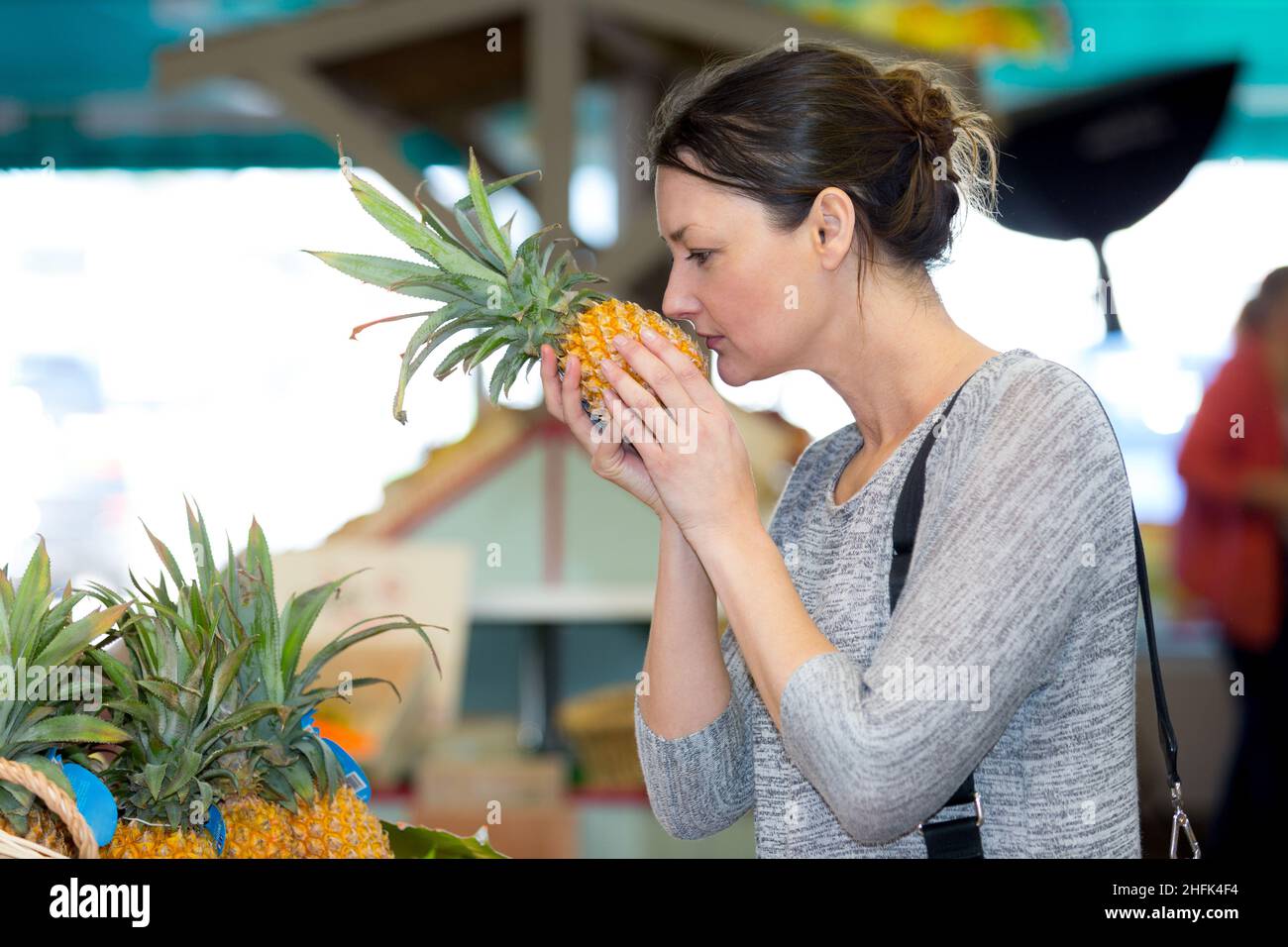 woman buying pineapple at organic section in supermarket Stock Photo ...