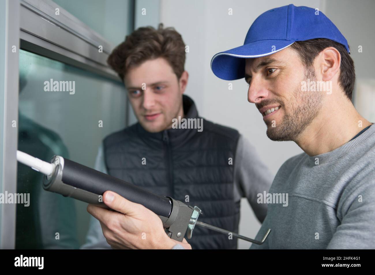 construction worker with a caulking gun Stock Photo - Alamy