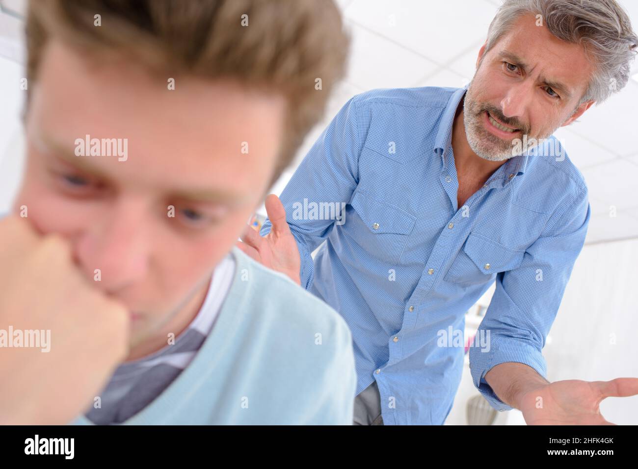 a man is telling teenager off Stock Photo - Alamy