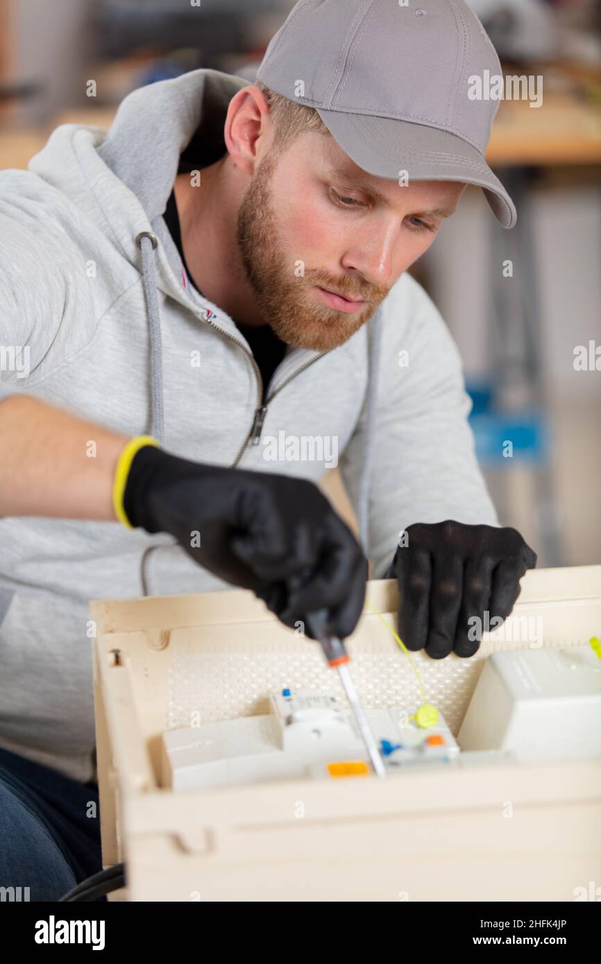 a young man is repairing a computer Stock Photo - Alamy