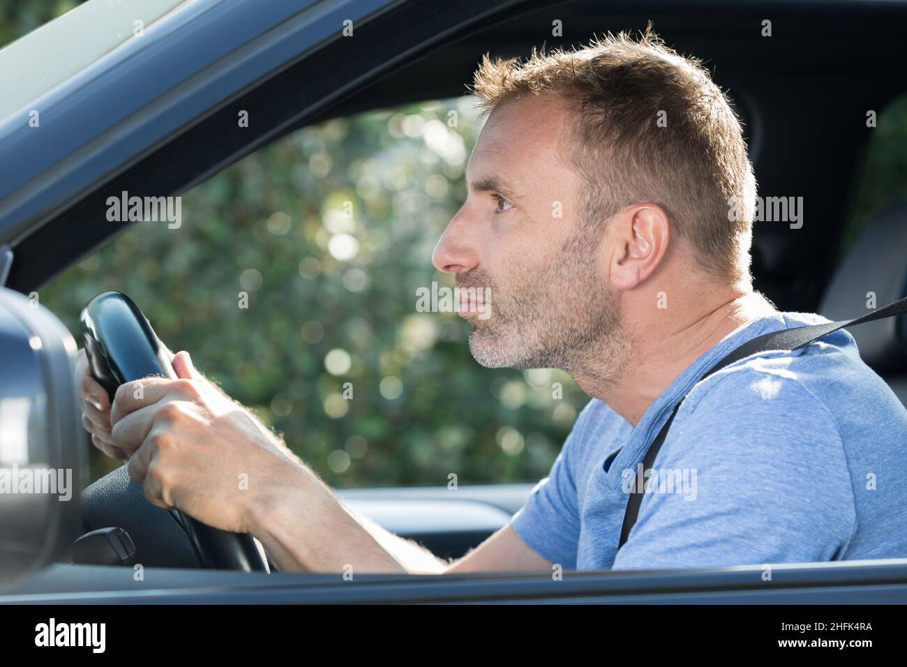 a concentrated man driving a car Stock Photo - Alamy