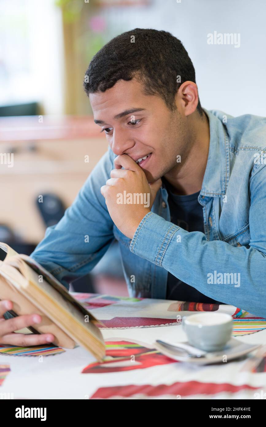 handsome man reading in a pub Stock Photo - Alamy