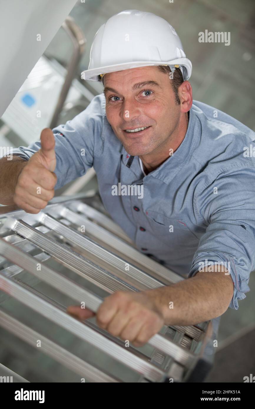 smiling construction inspector with his thumb up Stock Photo - Alamy