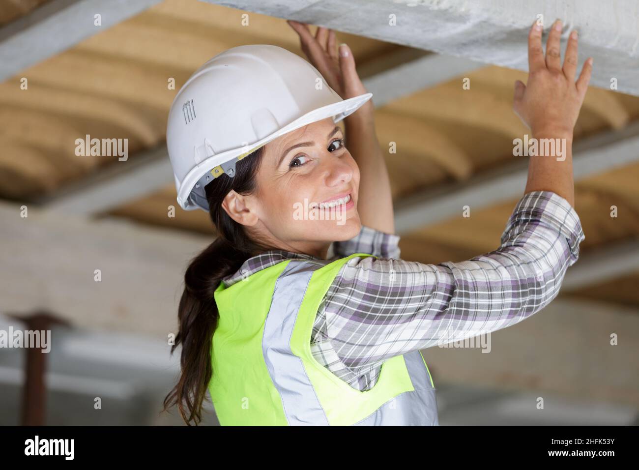 Young woman painting wall checking hi-res stock photography and images ...