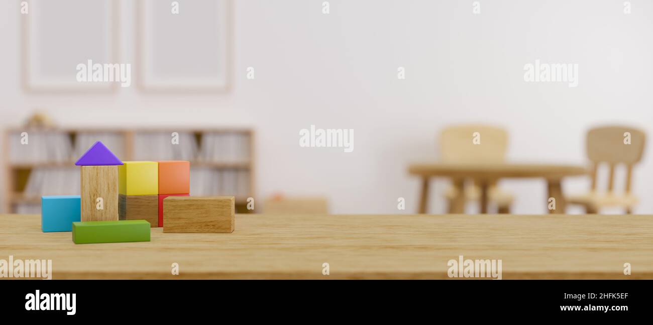 A copy space on wooden tabletop with kids toy over blurred kids nursery ...