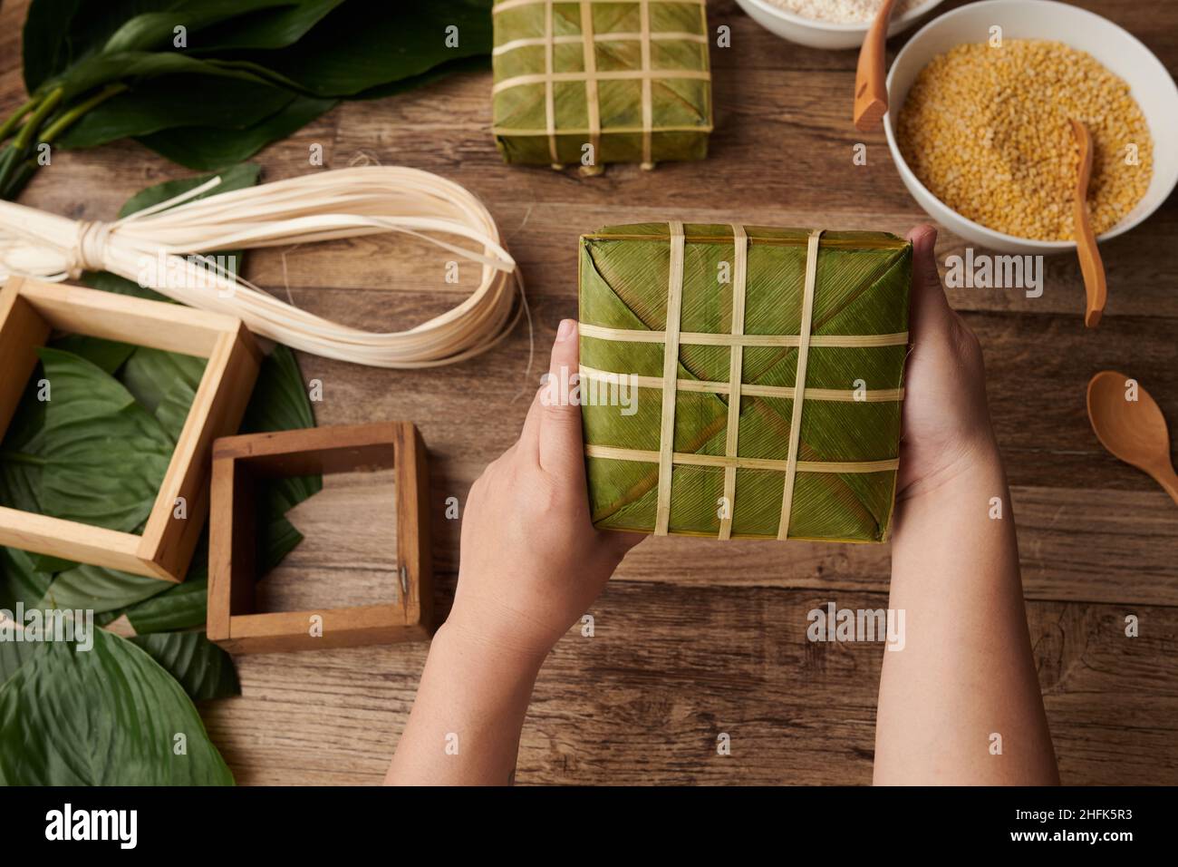 Hands of person making traditional sticky rice cakes for Chinese New ...