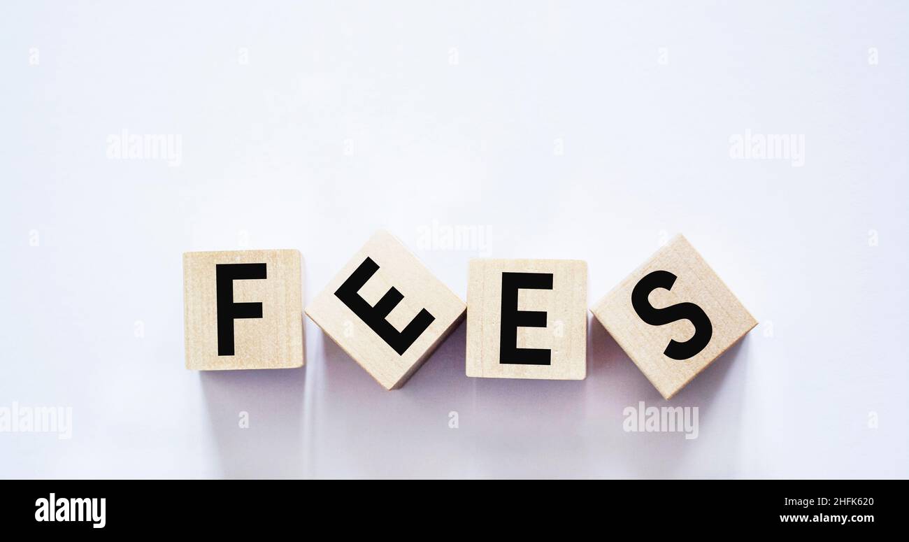 Wooden blocks with the word Fees on a white background. Fixed price for ...