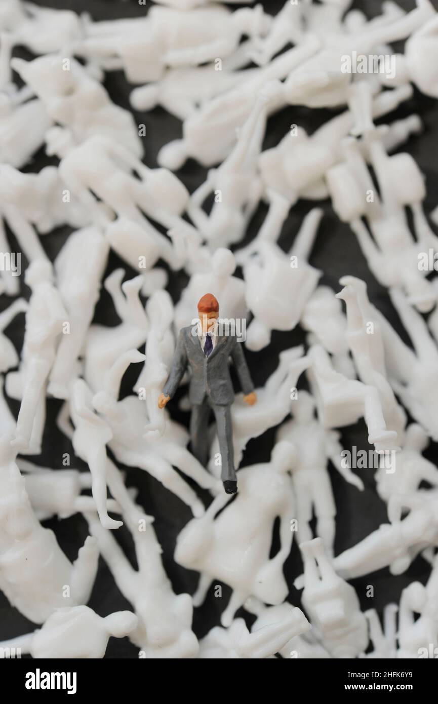 blank molded plastic miniature figurines with one painted, standing out ...