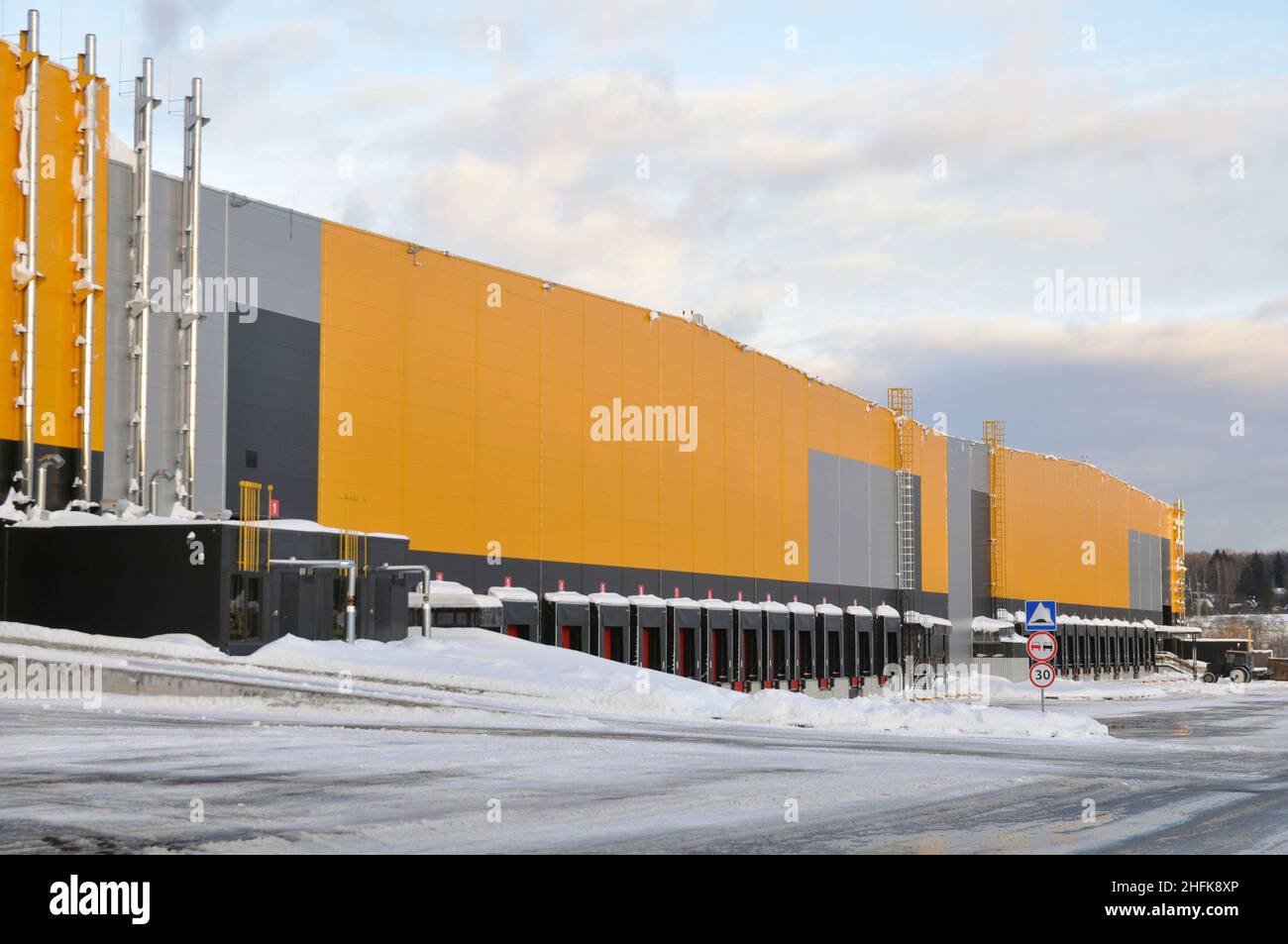 Exterior view of a large warehouse in winter. Driveways. Logistics ...