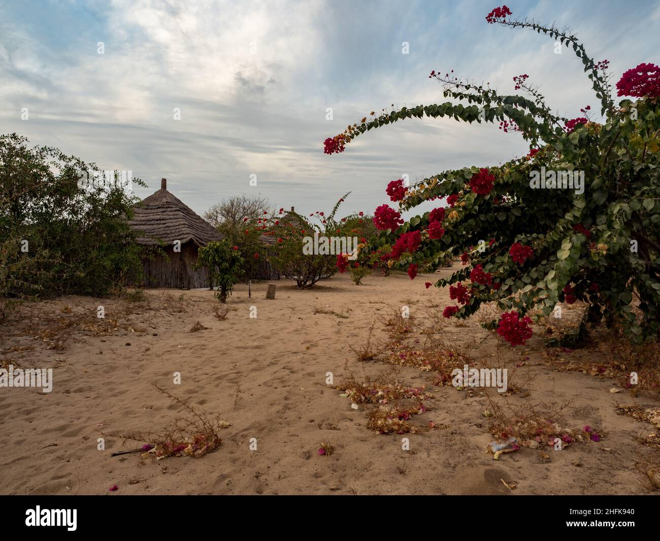 A small white house with a grass roof above Mbodiene Lagoon. Senegal ...
