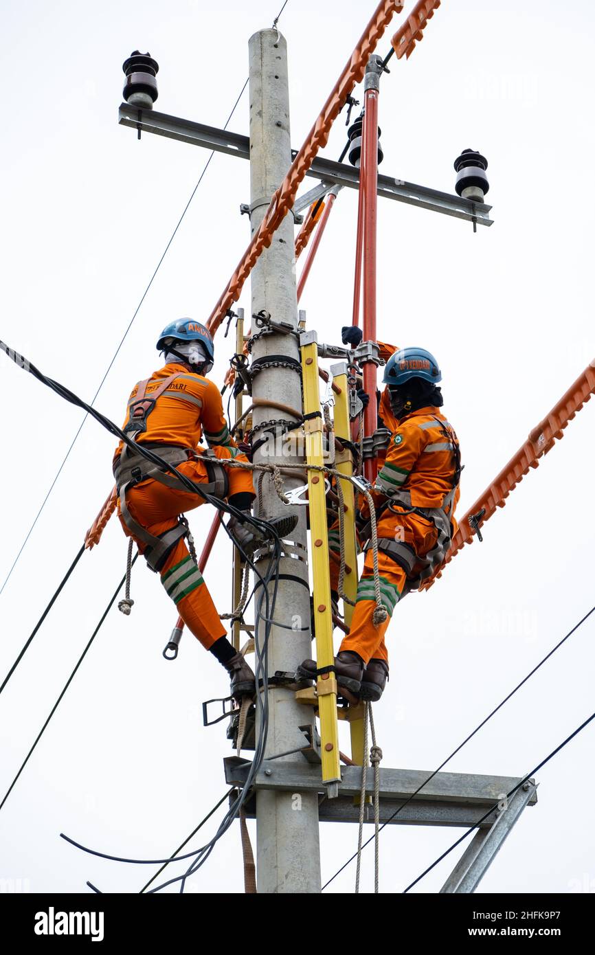 Kendari, Indonesia. 17th Jan, 2022. Workers from the state electricity ...