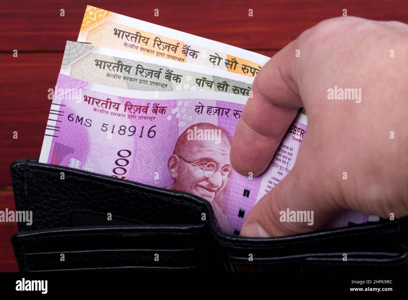 Indian money - rupee in the black wallet Stock Photo - Alamy