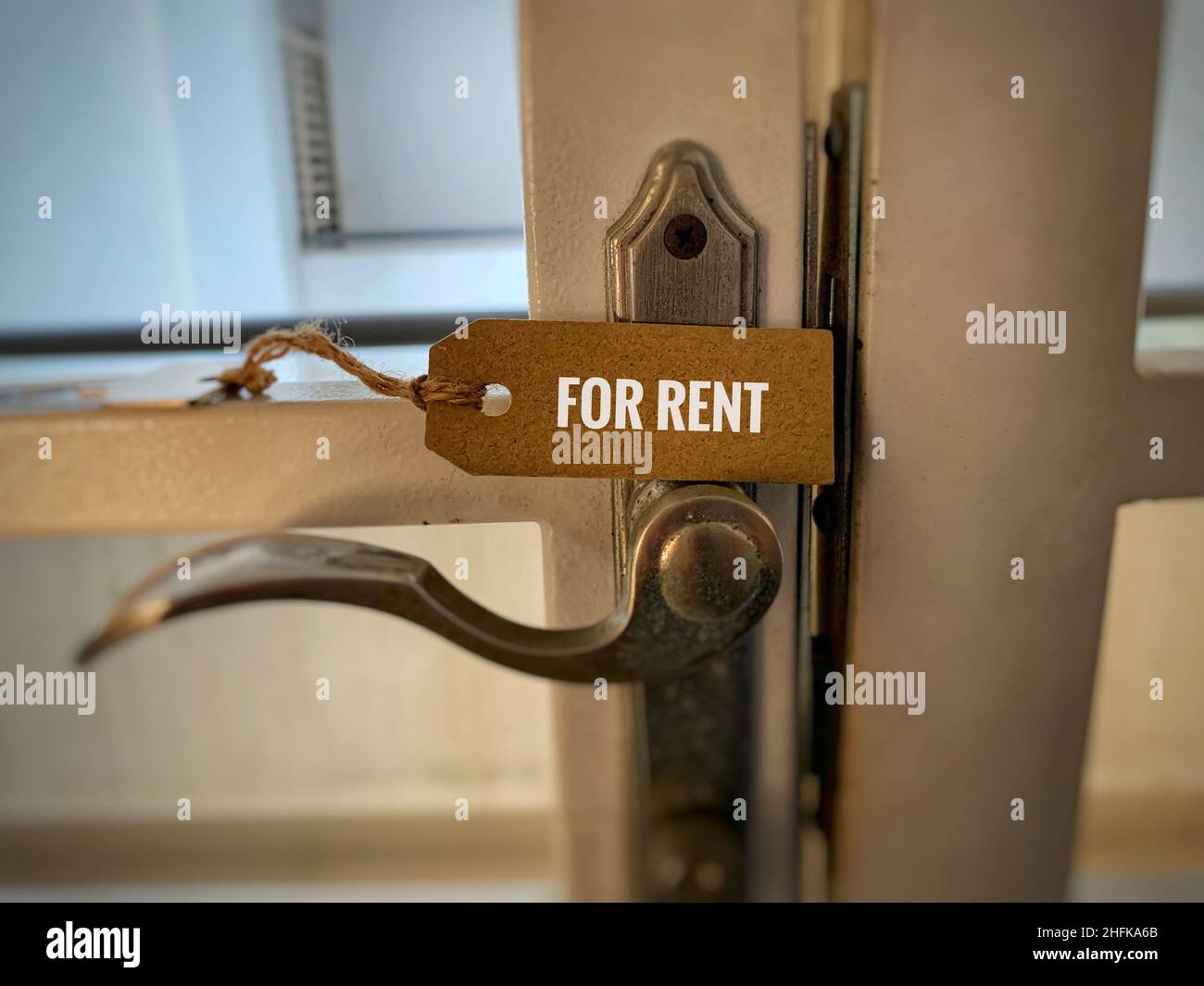 For rent label on brown paper tag with key and gate background ...