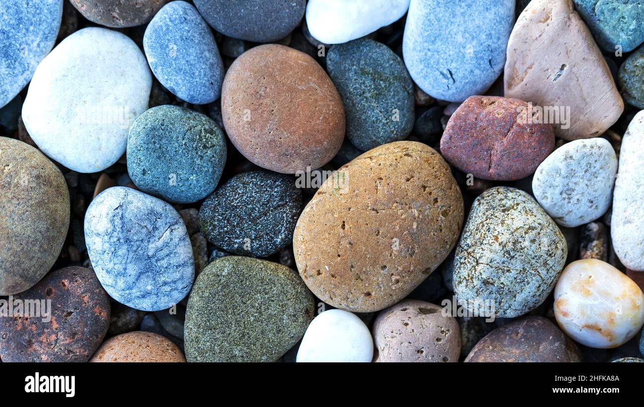 Round flat colorful stones on the bank of Baikal lake. Natutal ...