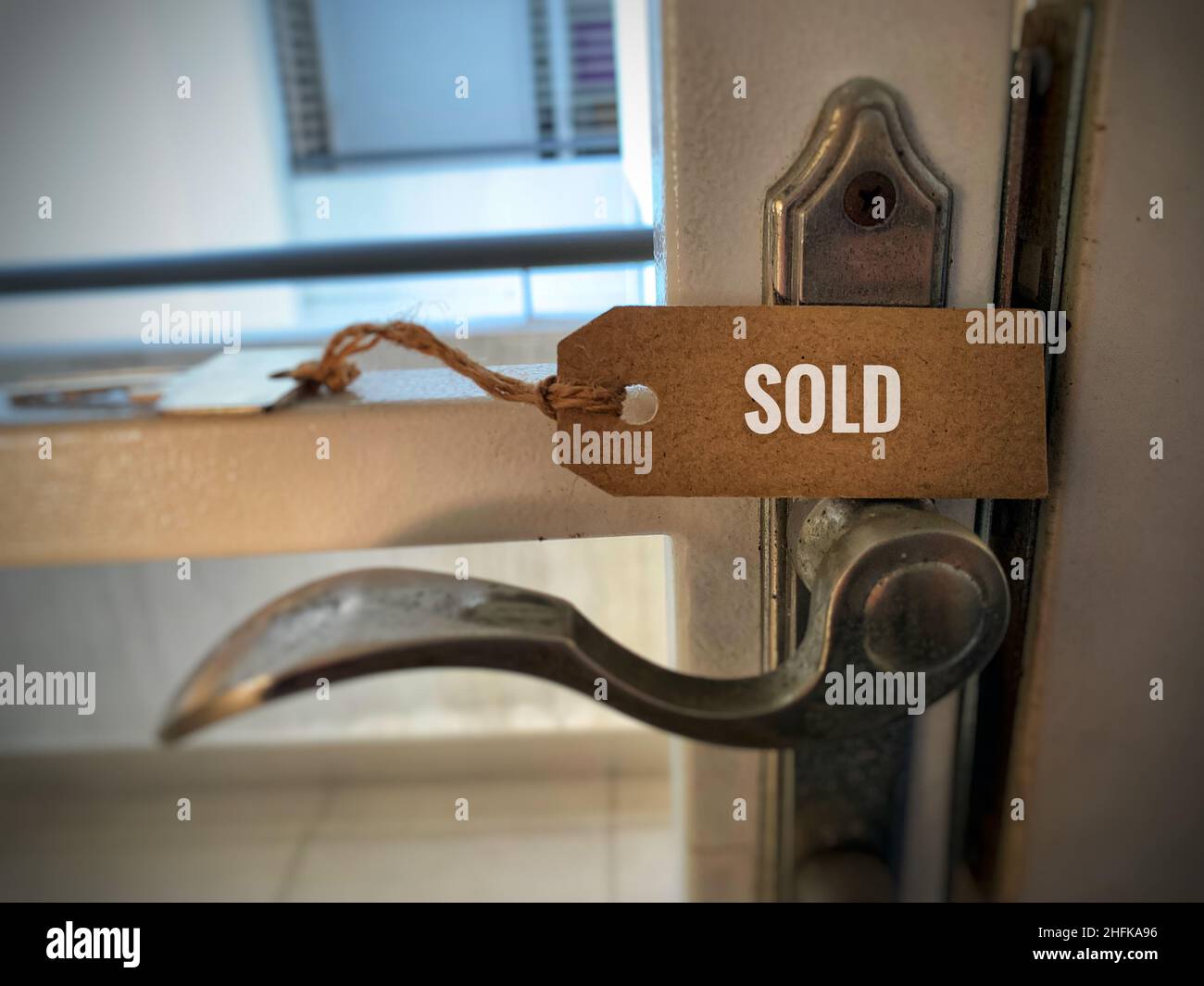 Sold label on brown paper tag with key and gate background. Property ...
