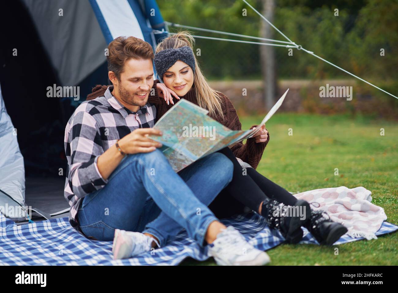 Young nice couple having fun on camping Stock Photo - Alamy