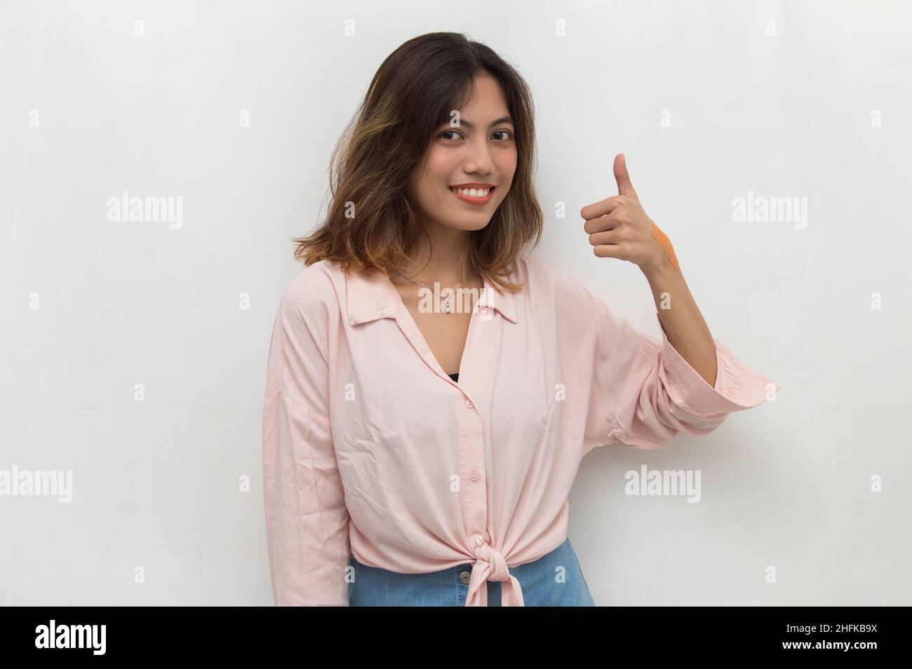 Young asian woman smiling and making OK sign with hand gesture Stock ...
