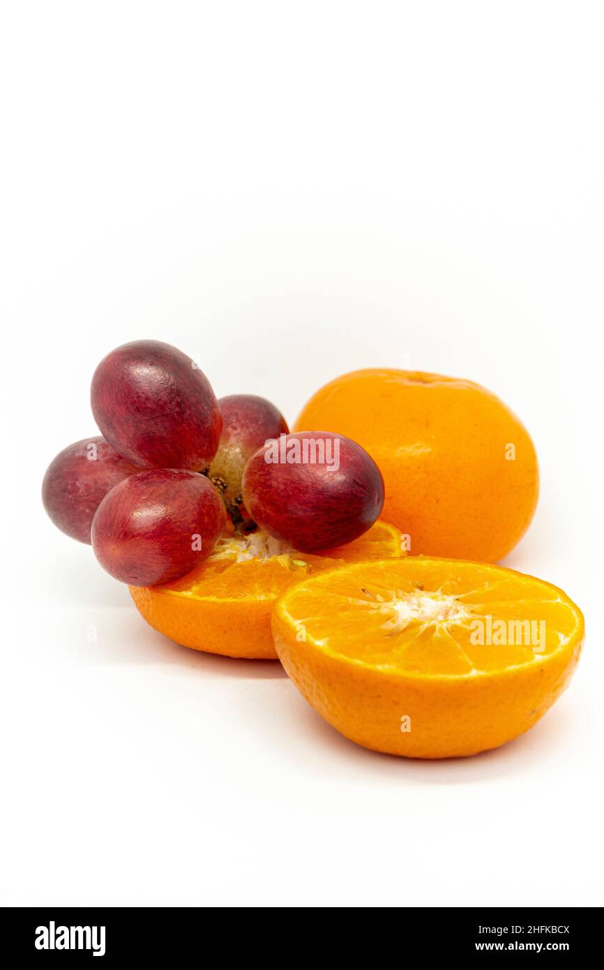 Grapes and oranges on a white background in a portrait position Stock ...