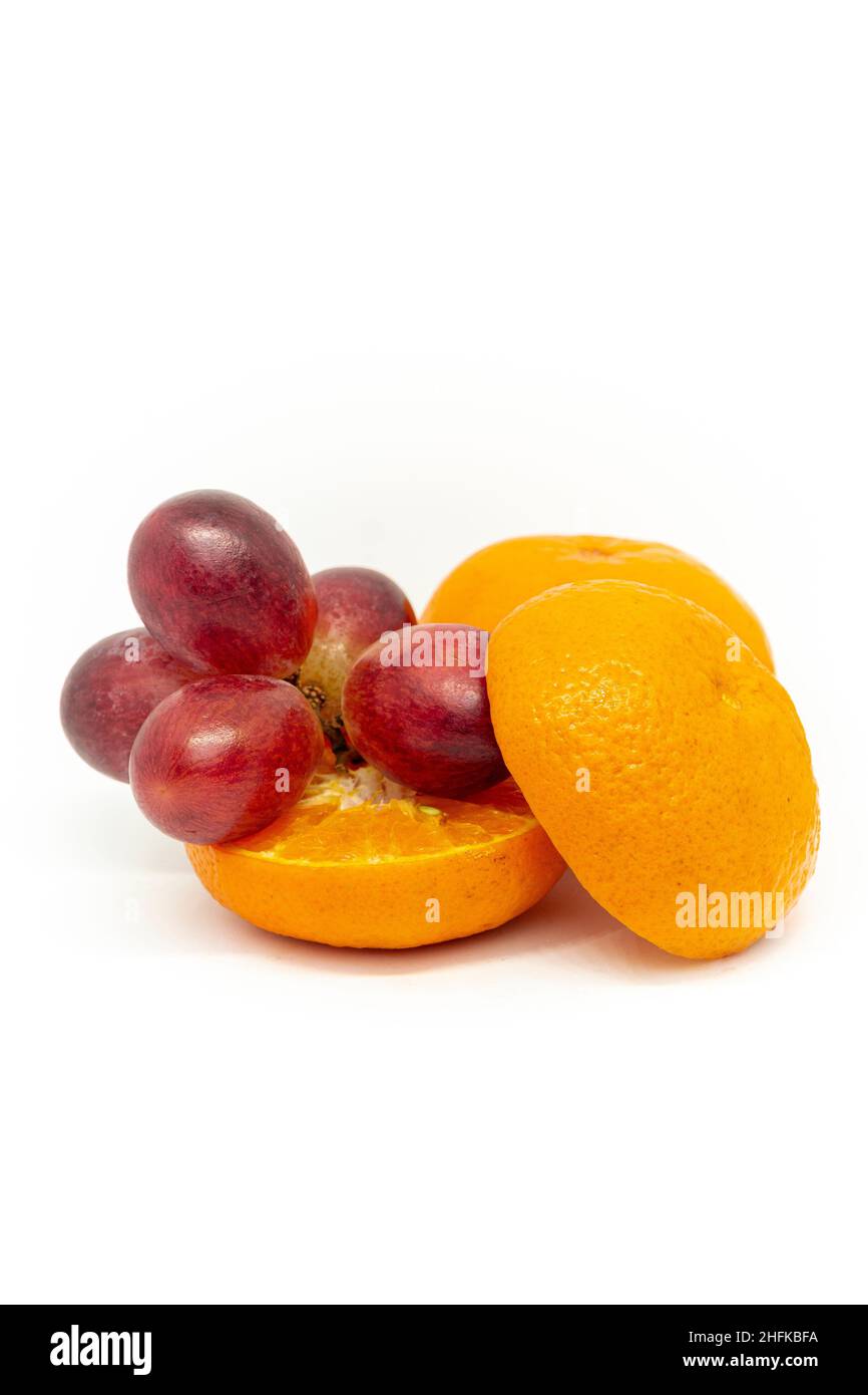 Grapes and oranges on a white background in a portrait position Stock ...