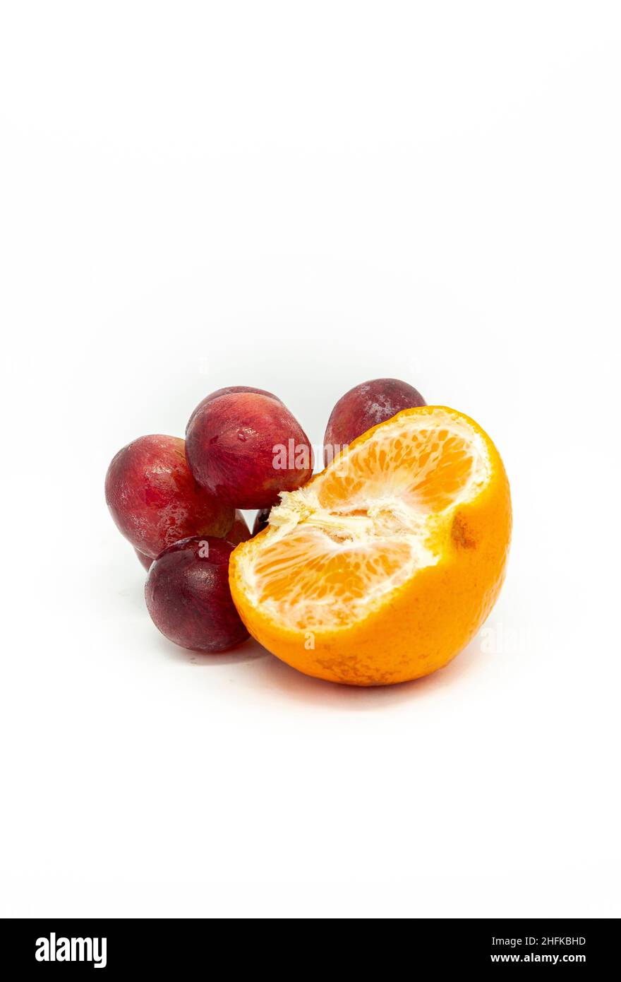 Grapes and oranges on a white background in a portrait position Stock ...