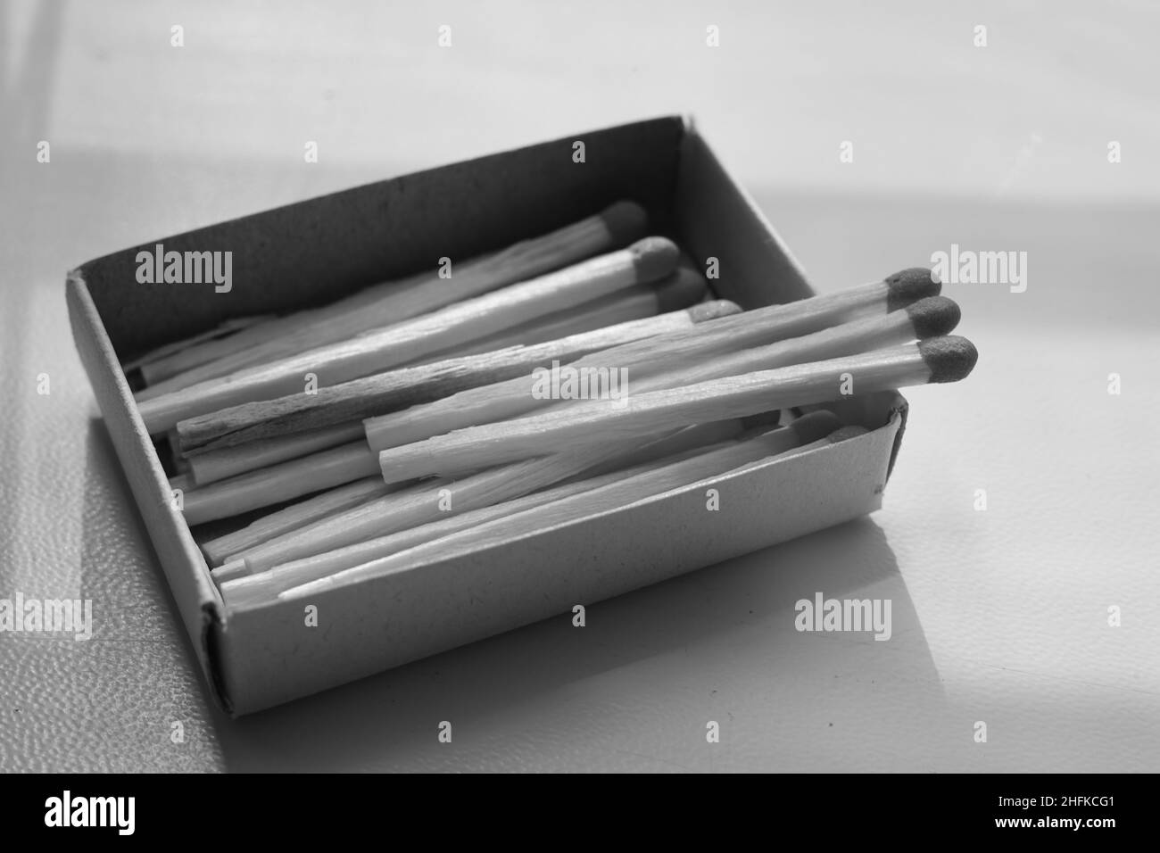 Cardboard box with matches on the table. BW photo Stock Photo - Alamy