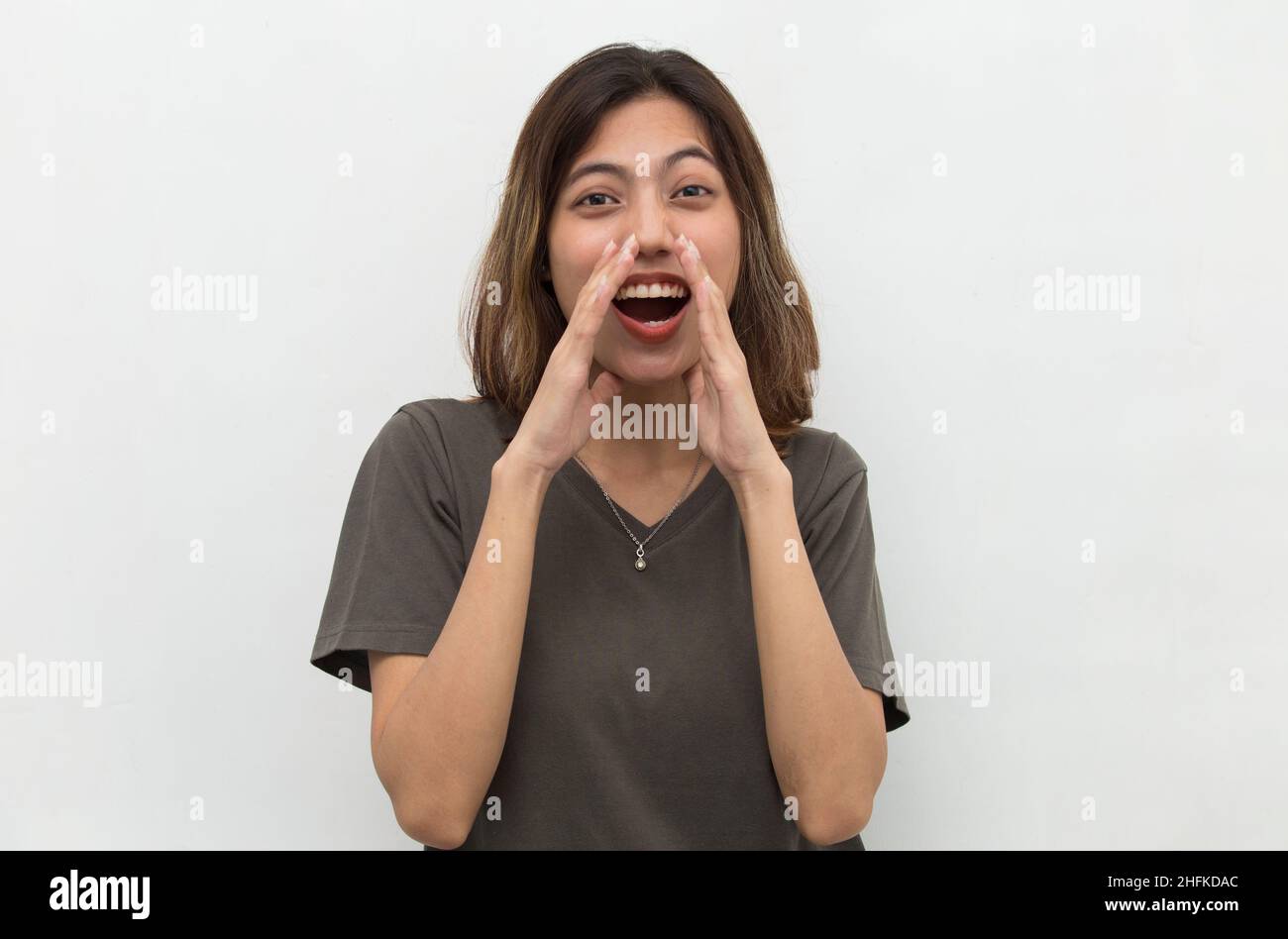 Cute Beautiful Asian woman shouting and yelling announcing Stock Photo ...