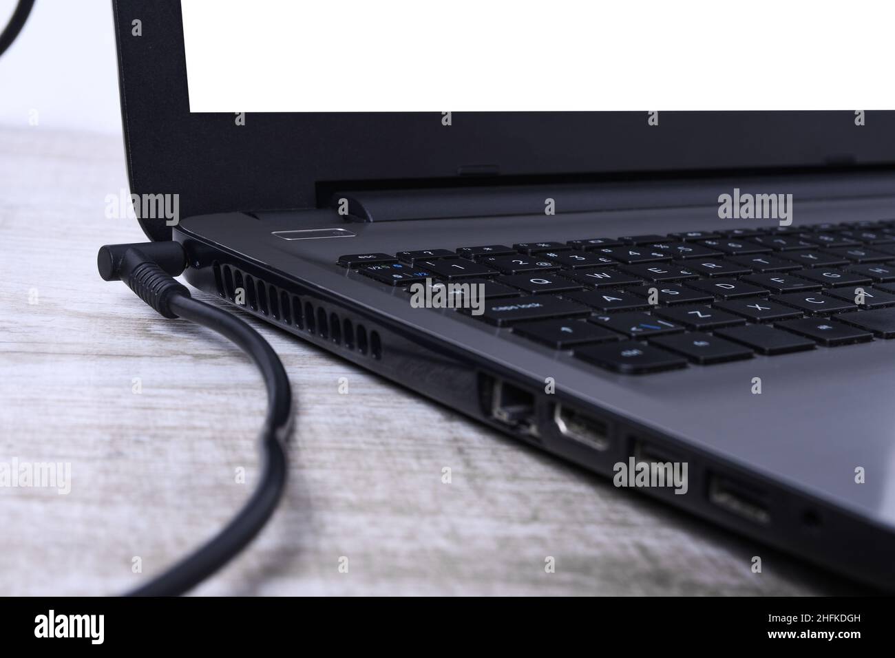 Laptop, computer is charging from a 220-volt outlet on a desk near the ...