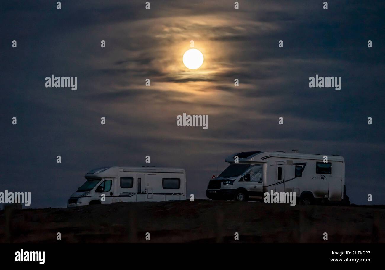The moon sets behind a campervan parked in the North York Moors ...