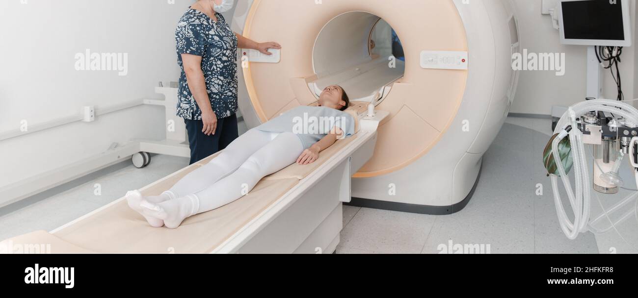 Doctor or nurse and patient with tomography CT or MRI Scan in hospital ...