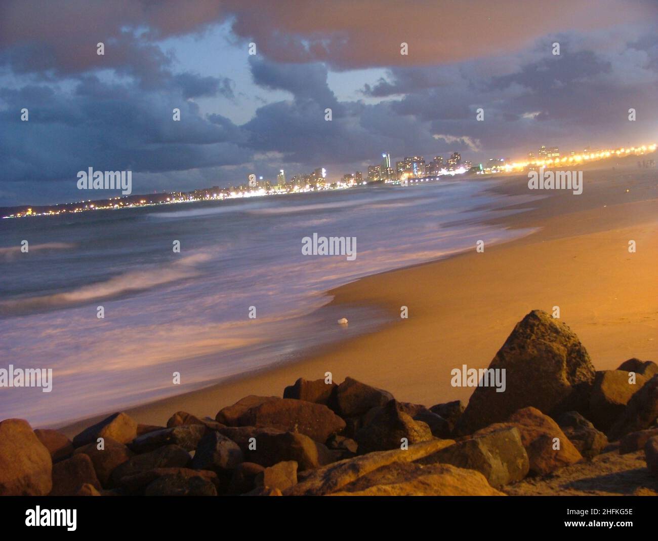 Durban Indian Ocean beach at sunset with city lights Stock Photo - Alamy