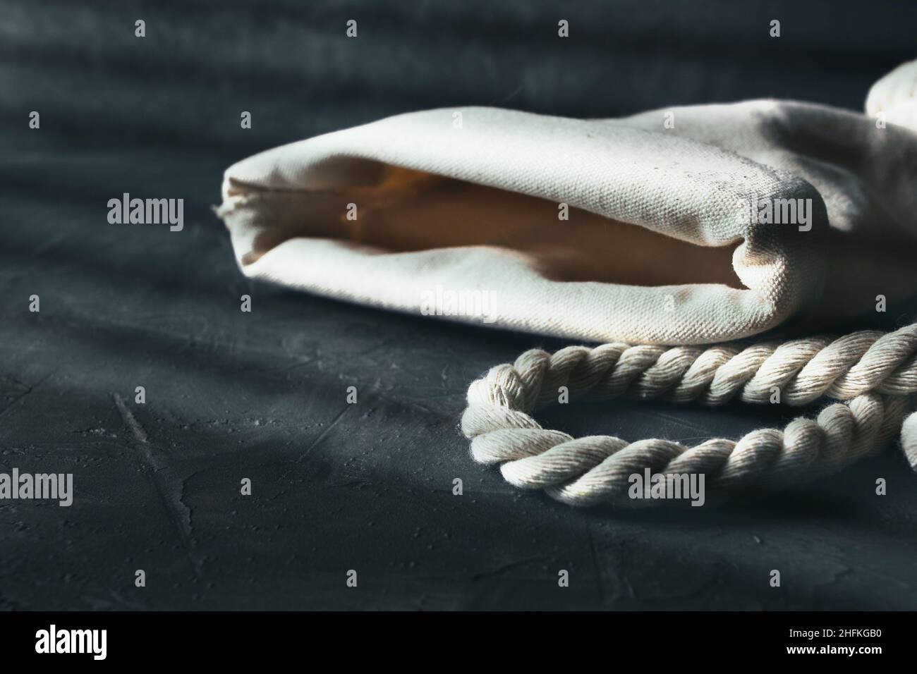 Old sack with rope in dark mood shot with warm window light. Background ...