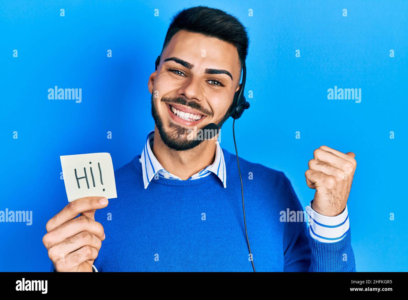 Young hispanic man with beard wearing operator headset showing hi ...