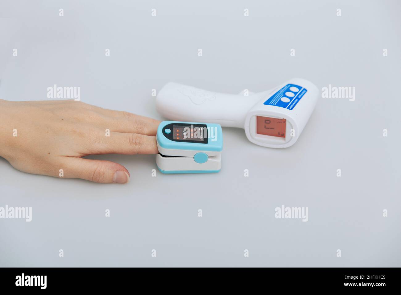 Pulse oximeter and thermometer gun on white background. Measuring ...